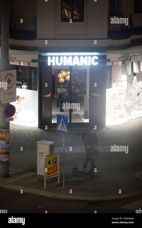 A Man Walks In Front Of The Humanic Store Vienna Austria At Night In Winter Photographed From