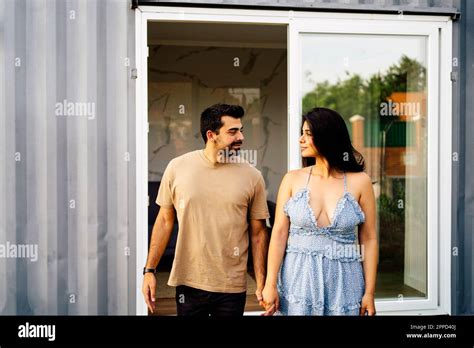 Romantic Couple Holding Hands Outside Container Home Stock Photo Alamy