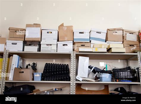 A Stack Of Office Supplies Piled High In A Storage Room Includes