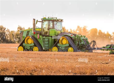 A Farmer Operating A Tractor On A Rural Agricultural Farm Tilling The
