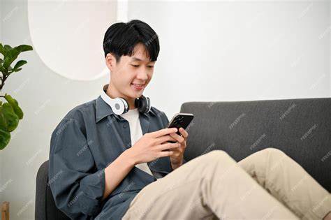 Premium Photo Side View Happy Asian Man Chatting With His Friends On