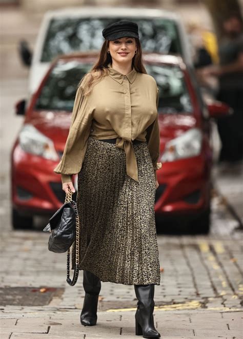 Kelly Brook Arrives At Heart Radio In A Busty Blouse And Pleated Skirt