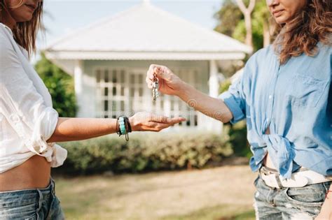 Real Estate Agent Giving Keys To New Property Owners Stock Image