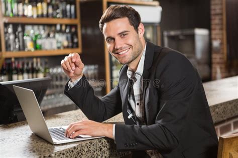 Handsome Man Using His Laptop While Relaxing On His Deck Chair Stock