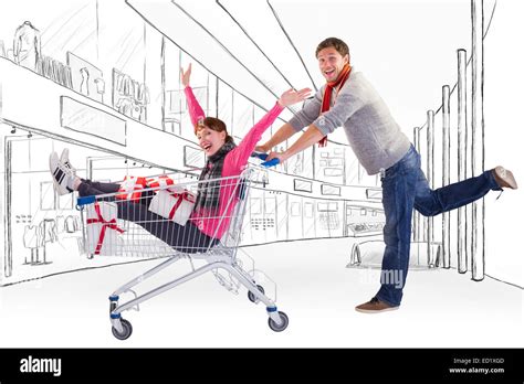 Composite Image Of Man Pushing Woman In Trolley Stock Photo Alamy