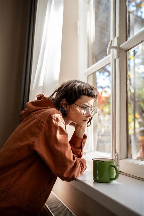 Nerd Teen Girl In Glasses Drinking Tea Coffee Looking At Window Boring At Home Friendless