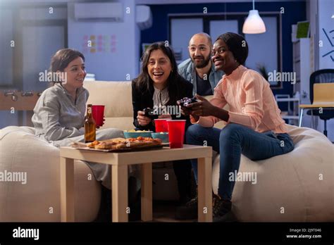 Multi Ethnic Diverse Group Of Friends Playing Fun Game On Tv Console