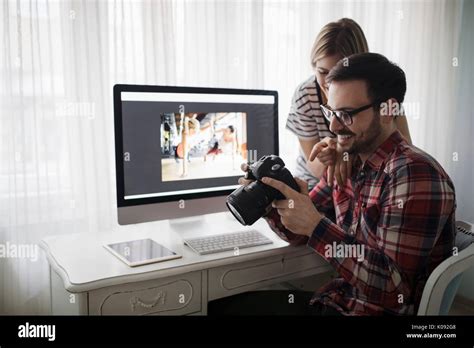 Beautiful Woman And Attractive Man Doing Design Work Stock Photo Alamy