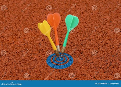 Red Green And Yellow Color Dart Arrows Hits Blue Target Stock Image