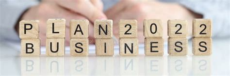 Business Plan Text On Wooden Cubes And Businesswoman With Pen Stock