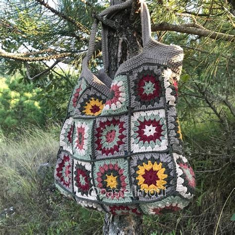 A Crocheted Granny Bag Hanging From A Tree