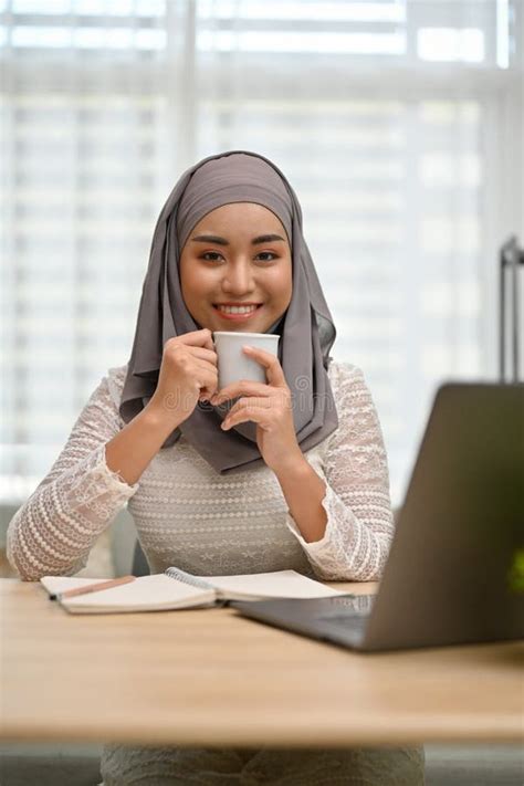 Asian Muslim Pregnant Woman Enjoying Watching Video On Tablet While