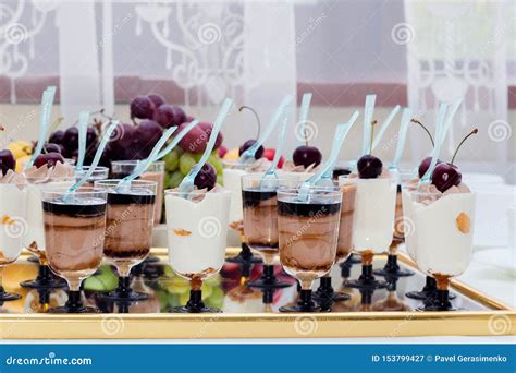 Traditional Italian Tiramisu Dessert With Chocolate Sauce In A Glass On