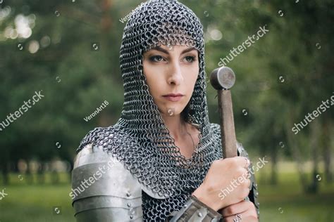 Medieval Girl Warrior In A Chain Mail Hood With A Sword In His Hand A