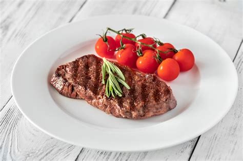 Premium Photo Beef Steak With Cherry Tomatoes And Rosemary