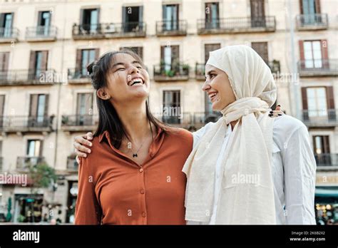 Multi Ethnic Female Friends Embracing Each Other And Laughing While