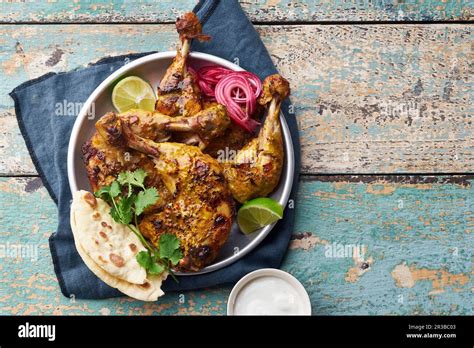 Tandoori Chicken Marinated In Tikka Served With Rice Naan Lime Plain