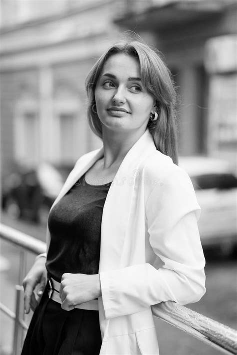 Elegant Woman In Stylish Outfit Posing Outdoors In Urban Setting Stock