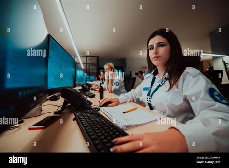 Group Of Security Data Center Operators Working In A Cctv Monitoring