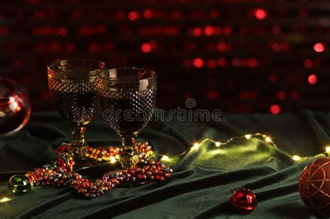 Glasses With Red Wine And Beautiful Christmas Decor On Table Space For
