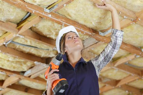 Female Builder Using Cordless Drill On Roof Timbers Stock Image Image