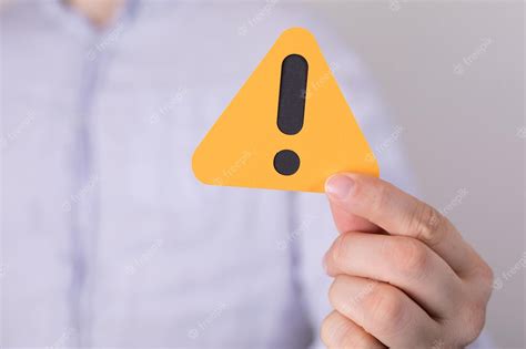 Premium Photo Man Holding A Yellow Triangular Warning Sign