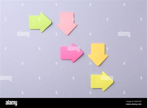Business Process Organization And Optimization Scheme With Arrow Shaped Paper Notes On Grey