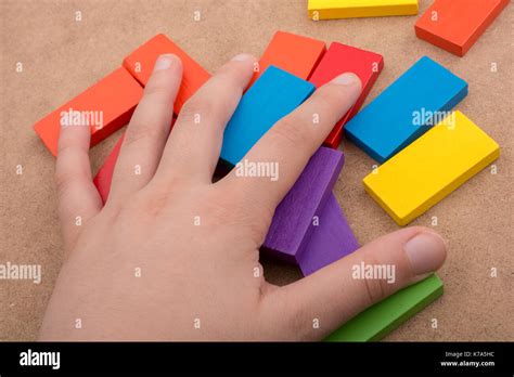 Hand Holding One Of The Wooden Blocks Of Various Colors Stock Photo Alamy