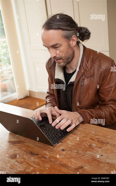 A Man Typing On His Laptop Stock Photo Alamy