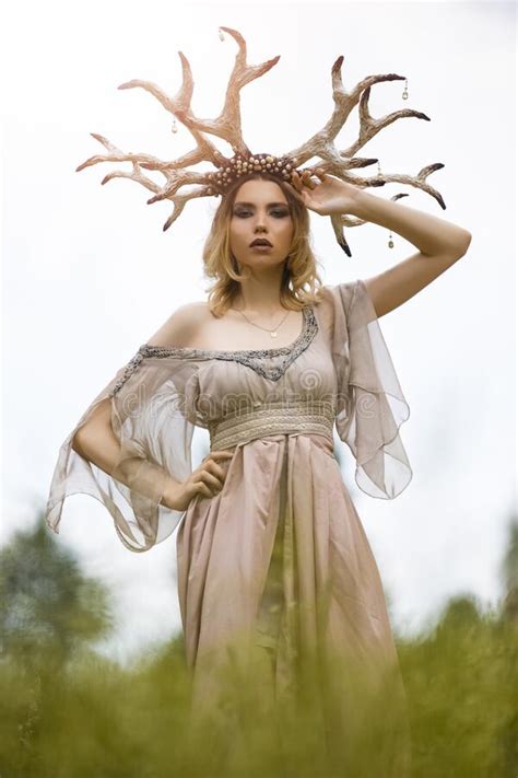 Young Beautiful Girl Posing With Artistic Deer Horns In Summer Forest