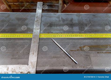Markings Metal Surface For Drilling Holes Worker Uses Tool To Measure