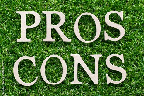 Wood Alphabet In Word Pros Cons On Artificial Green Grass Background