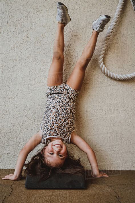 Cute Girl Doing Handstand Upside Down Smiling Stock Photo Dissolve