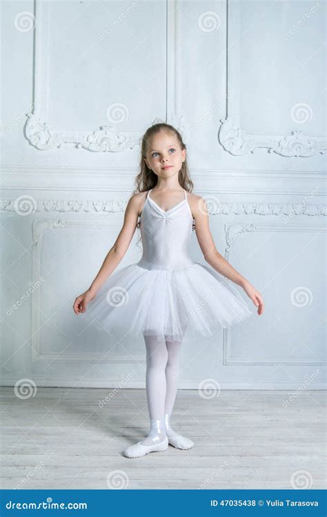 A Little Adorable Young Ballerina Isposing On Camera In The Interior
