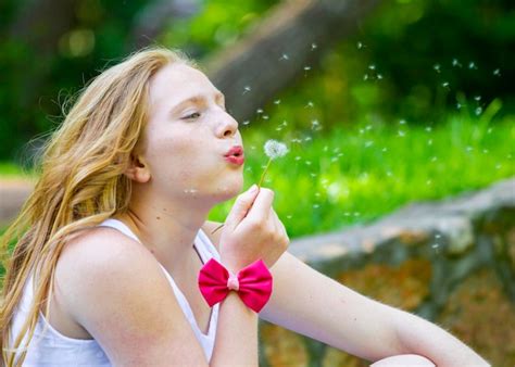 Premium Photo Woman Blowing Dandelion Outdoors