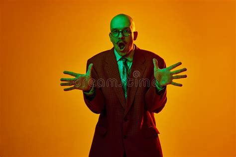 Portrait Of Young Bald Man With Moustache Wearing Suit And Glasses