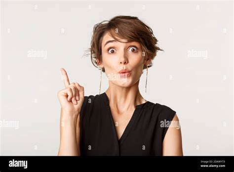 Close Up Of Attractive Girl Have An Idea Raising Finger In Eureka