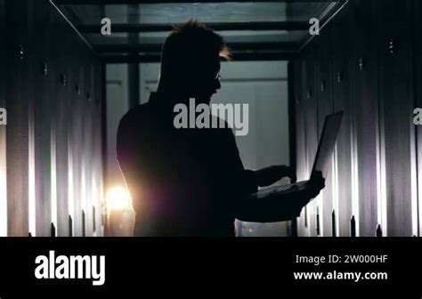 Programmer Types On A Laptop Working At A Data Center Computer System