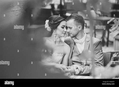 Happy Couple Kissing While Sitting In Street Cafe The Bride And Groom
