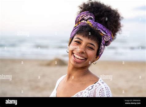 Young Girl Of African Descent Smiling At Sea At Sunset Smiling With