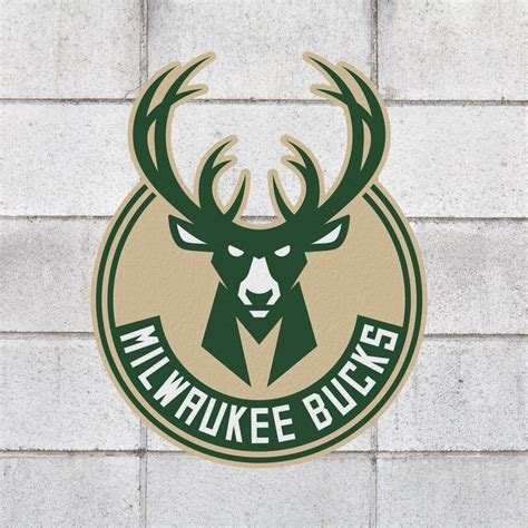 The Milwaukee Bucks Logo Is Shown On A Brick Wall In Front Of A Cement Wall