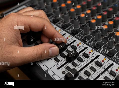 Close Up Of A Male Hand Changing Volume On Mixing Board Creating Music