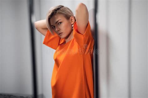 Blonde Inmate In An Asian Women`s General Security Prison Is Led Out Of