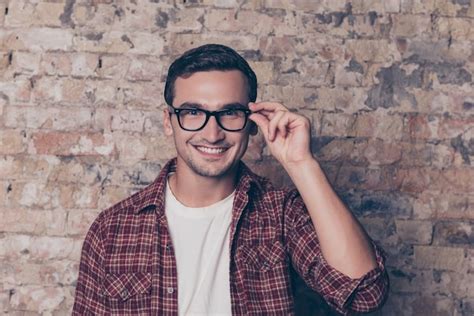 Premium Photo Portrait Of Happy Toothy Smart Man Touching His Glasses