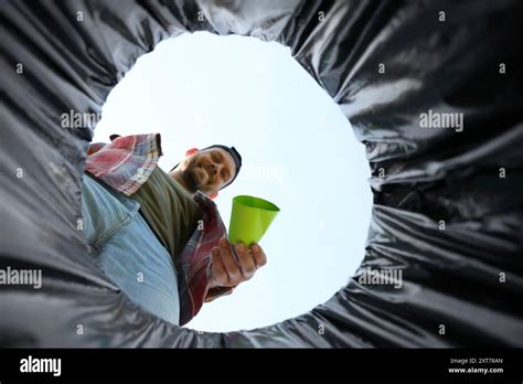 Man Throwing Garbage Into Trash Bin Outdoors Bottom View Stock Photo Alamy