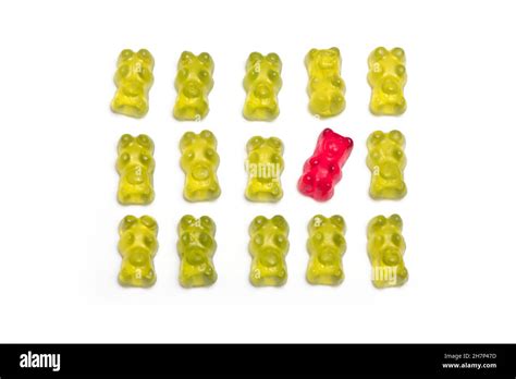 Rows Of Green Gummy Bears In Which One Red Guy Behaves Differently From