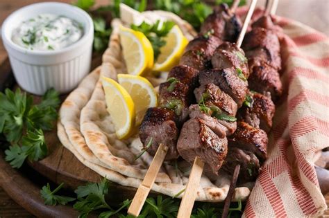Premium Photo Lamb Kebabs With Flatbread Lemon And Tzatziki Sauce