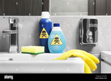 Bottles Of Toxic Household Chemicals With Warning Signs Gloves And