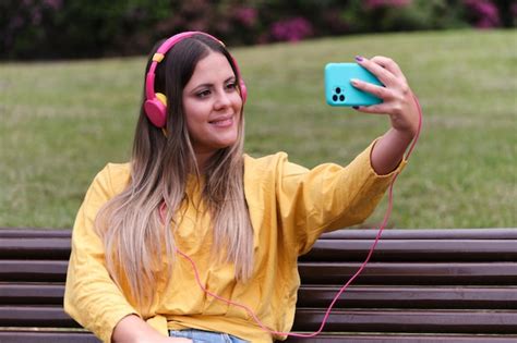 Premium Photo Young Girl Takes A Photo With Her Phone While Listening