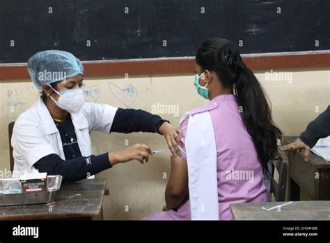 A Health Worker Inoculates Coronavirus Vaccine To A Youth During A